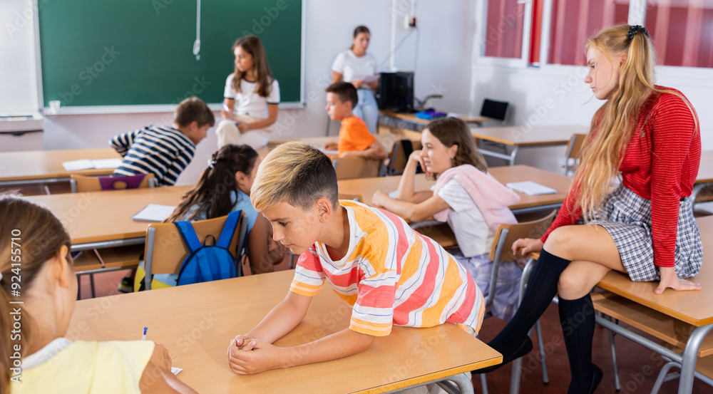 Happy schoolchildren resting at recess between lessons in classroom ...