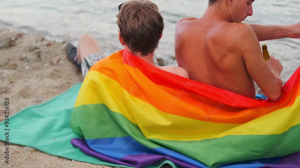 Date of two friends sitting on of sand beach with a blanket with an ...