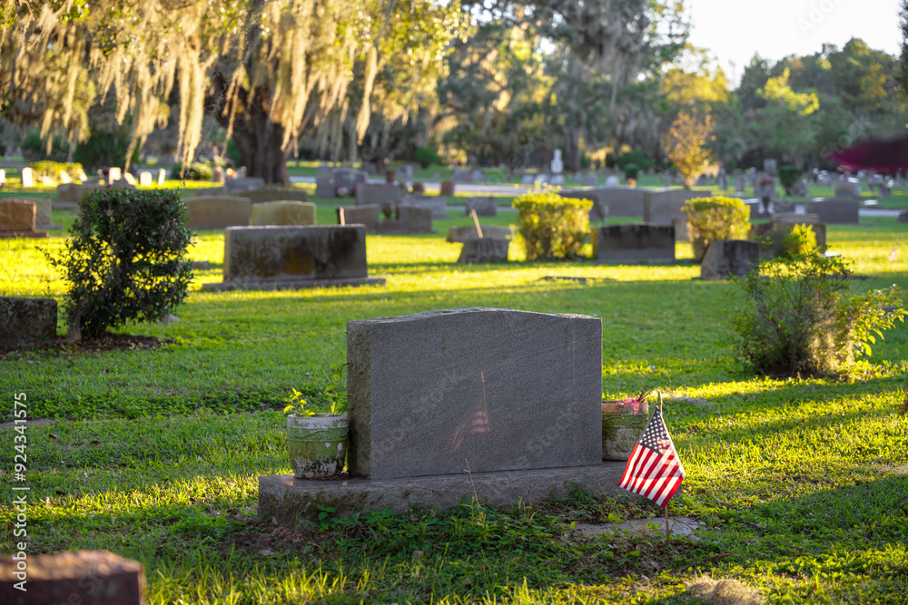 Old American cemetery with rows of tombstones under southern oak trees ...