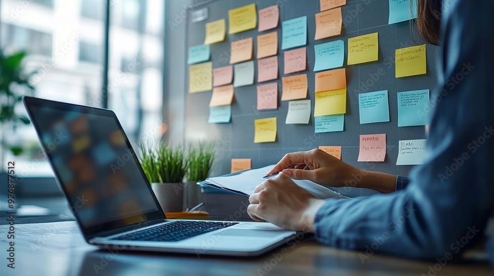 Business developer using Kanban board framework on laptop computer. Agile software development ...