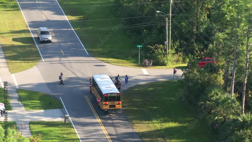Students boarding school bus at bus stop before going to lessons ...