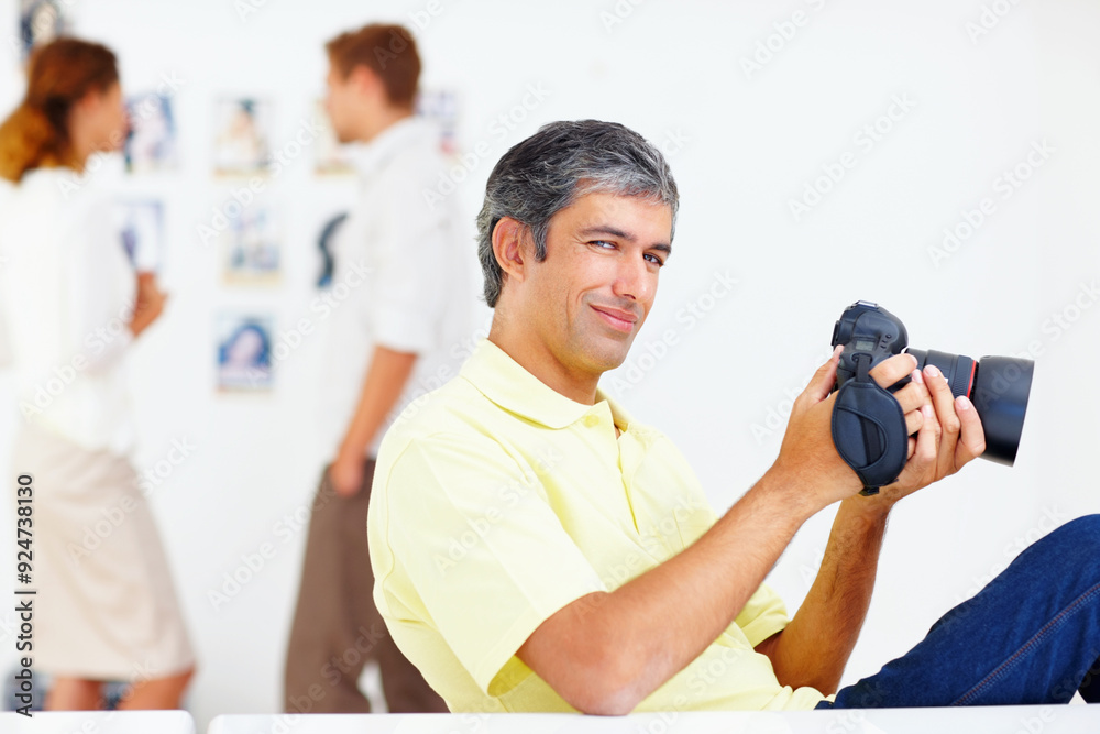 Mature man, portrait and photographer in office, review camera picture ...