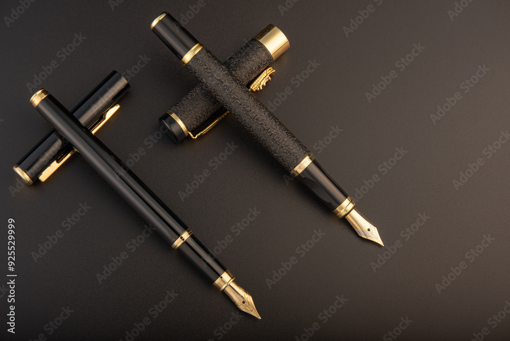 Fountain pens, beautiful black and gold fountain pens, positioned on ...