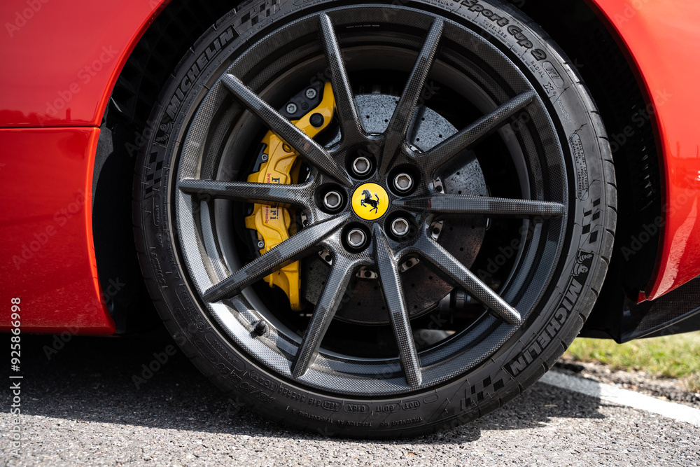 Ferrari logo sign on a car wheel with brake caliper. Italian luxury ...