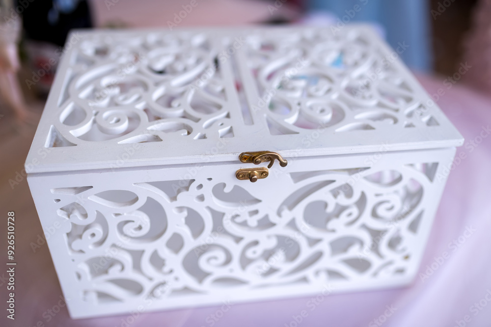 Elegant white decorative box with intricate cut-out design. A ...