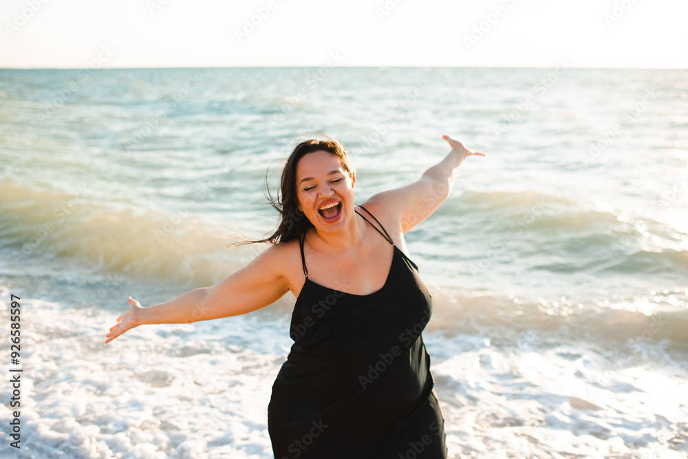 Laughing overweight woman 30 - 35 year old wearing black dress at black ...