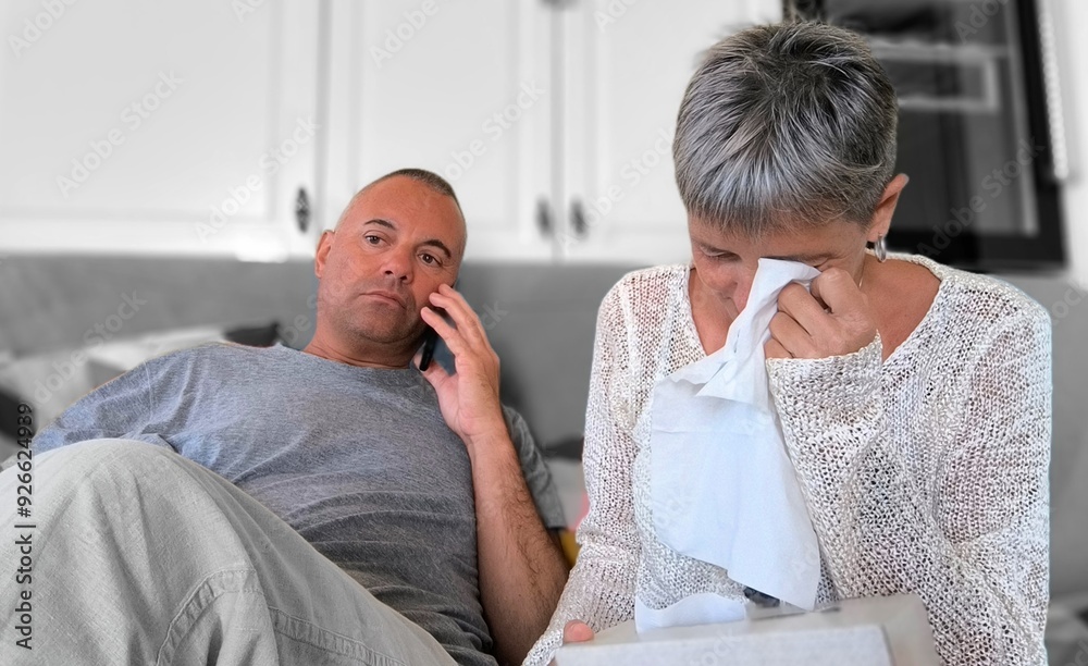 Couple on the couch, she cries, he talks on the phone.Couple arguing ...