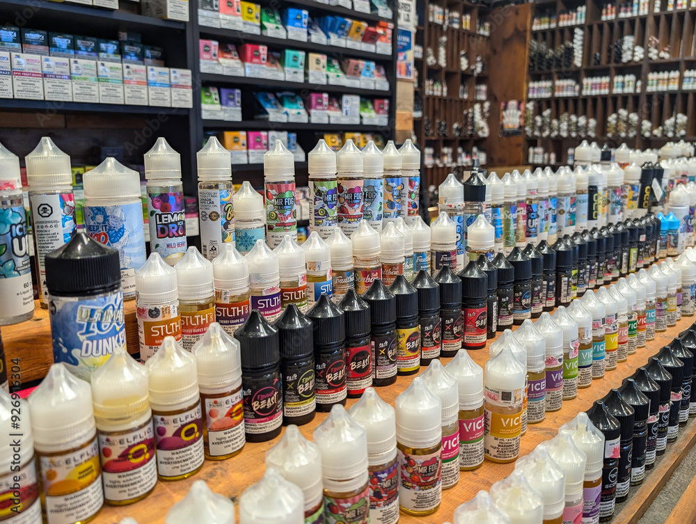 Multiple single use disposable vape devices and many bottles with ...