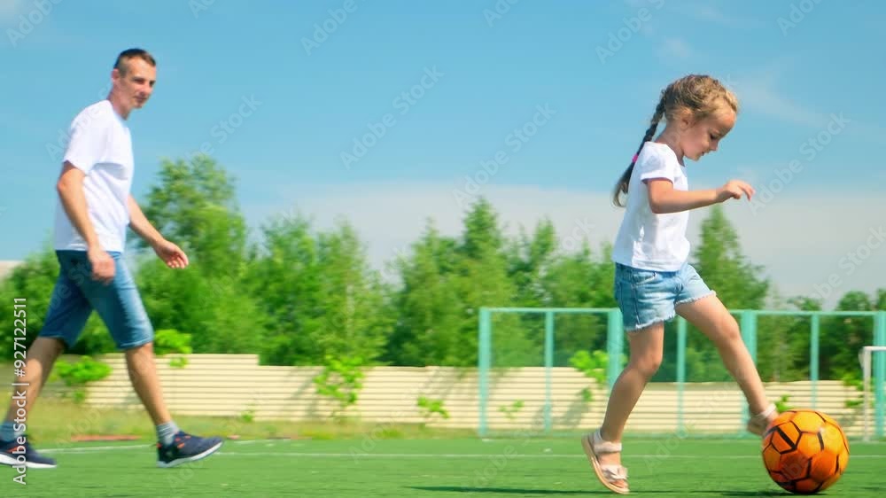 Father and daughter play football. Dad and little girl play soccer ...