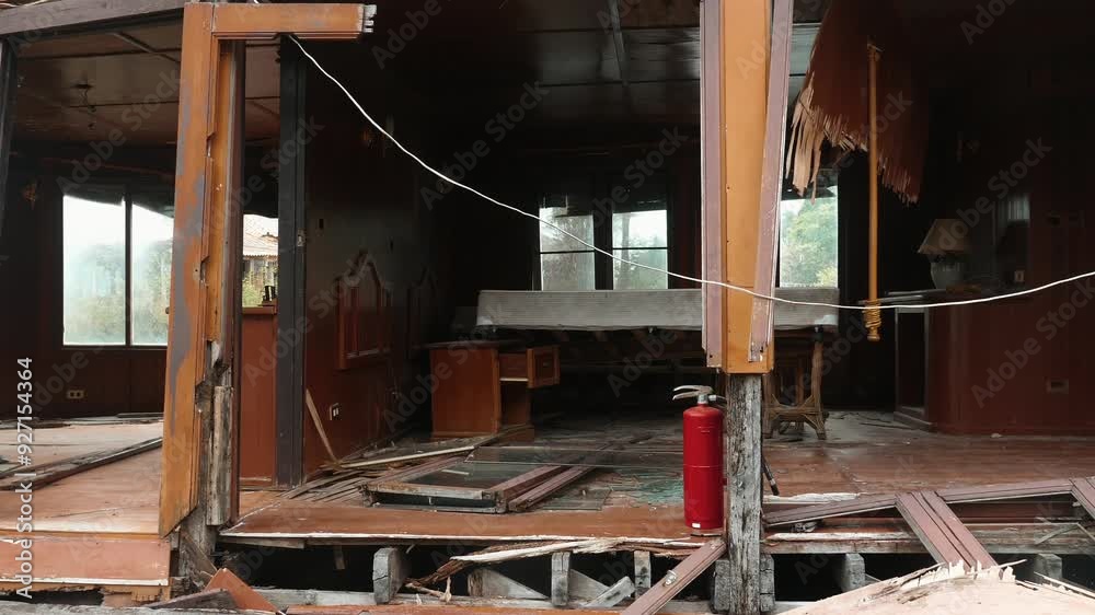 Abandoned house interior with exposed walls, broken windows, and ...