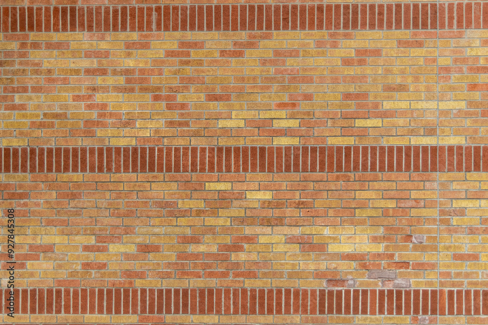 Warm-toned brick wall with varying shades of red and orange bricks ...