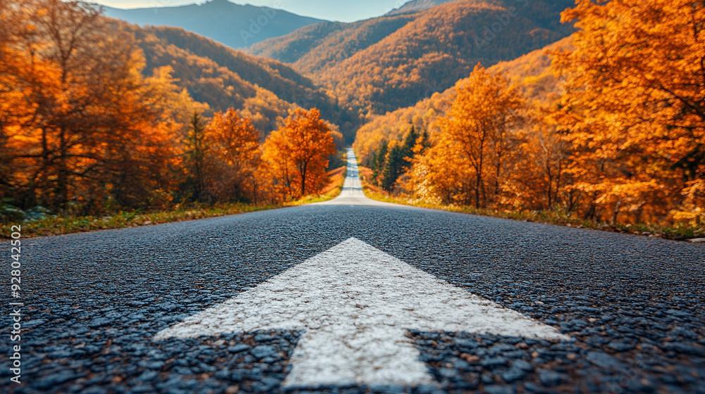long, empty asphalt road stretches into the distance, with a prominent ...