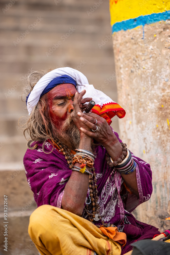 Portrait of an old male indian sadhu with red paint o baba sitting on ...
