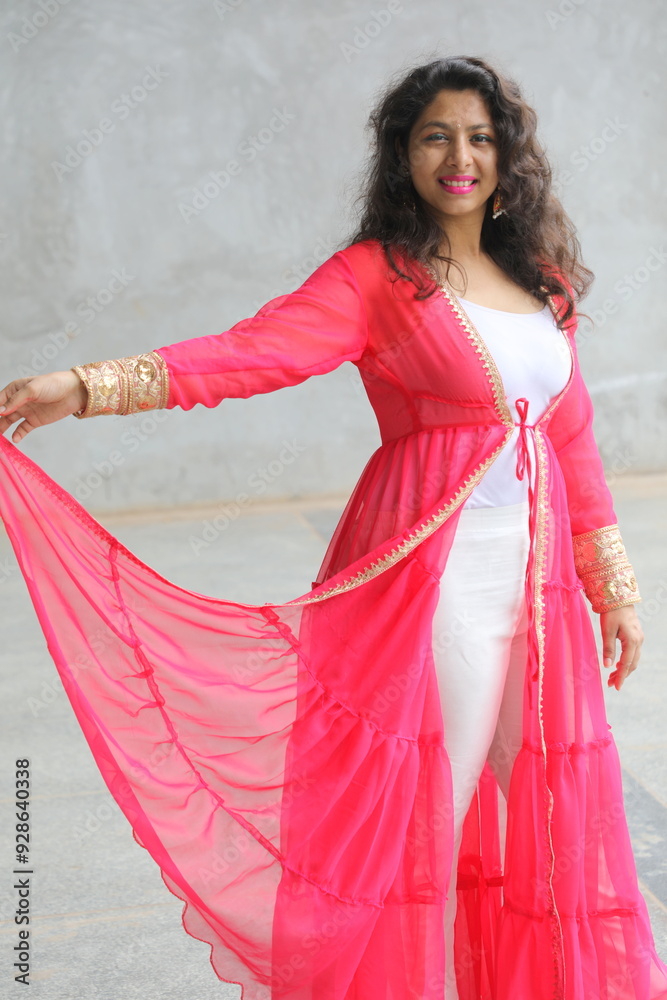 woman is wearing ruffled pink shrug and posing in a style. Indian model ...