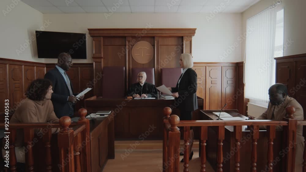 Female prosecutor and male attorney standing in front of each other ...