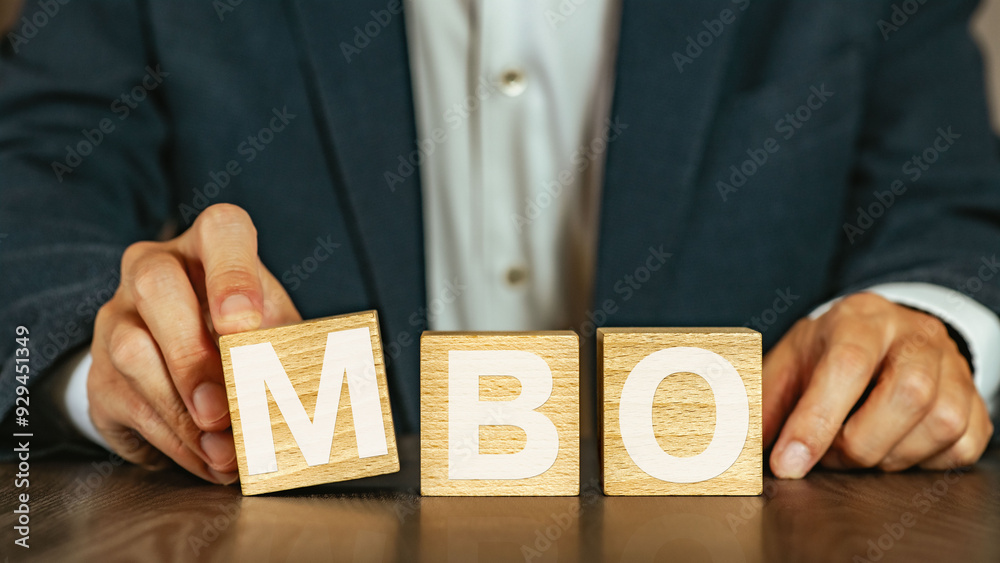 There is wood cube with the word MBO. It is an abbreviation for ...