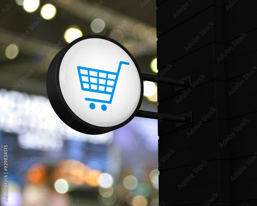 Shop cart icon on hanging black rounded signboard over blur light and ...