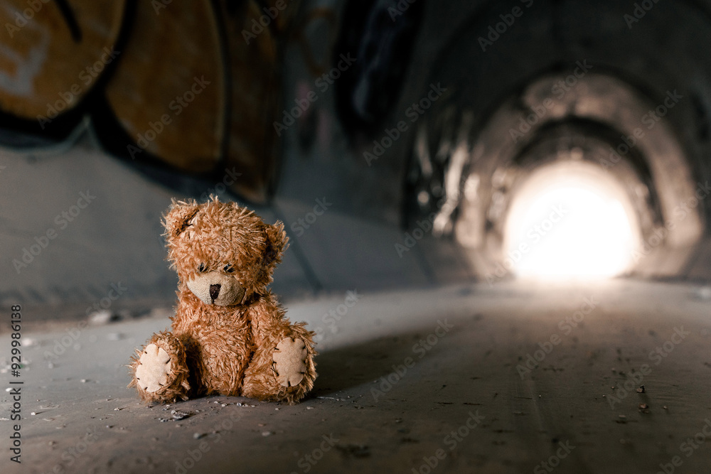 Homeless poor teddy bear in a dark tunnel. Homelessness, poverty ...