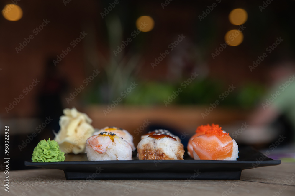 Temarizushi or Japanese rice balls served on the black plate in the ...