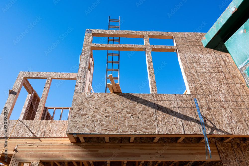 New residential home construction in framing stage, looking up at ...