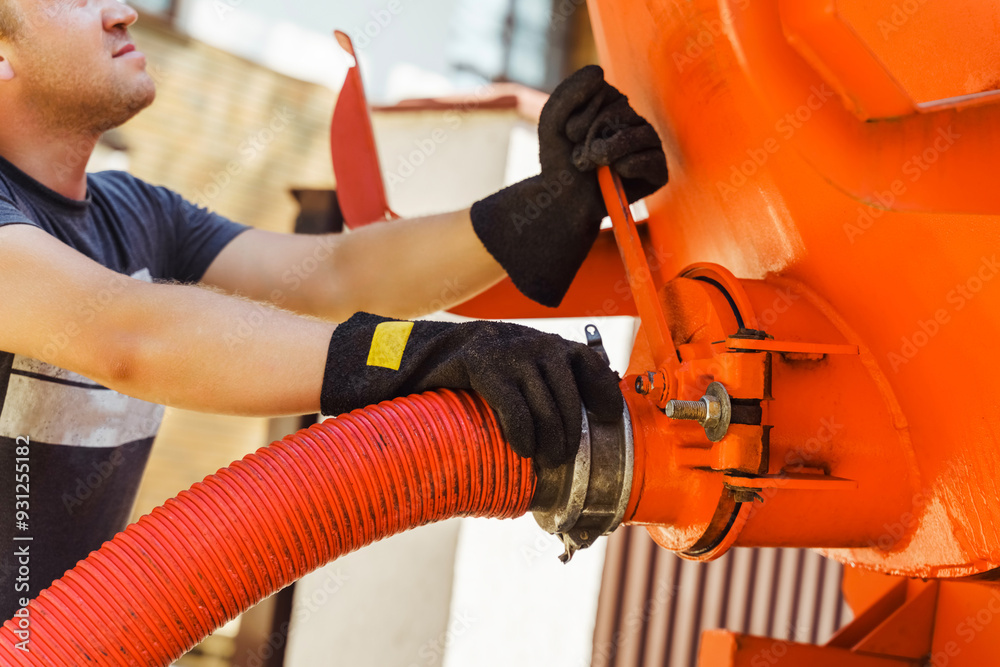 man connects a suction hose to a sewage tanker truck. Sewer pumping ...