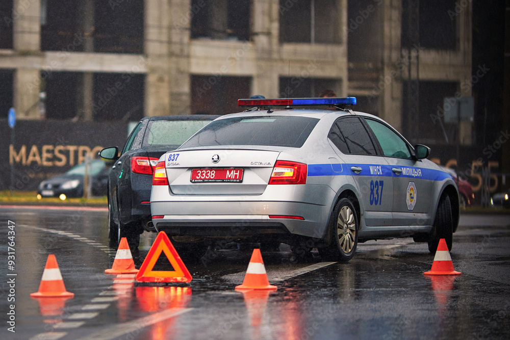 Minsk, Belarus. Jul 29, 2024. Wet road with police car and orange cones ...