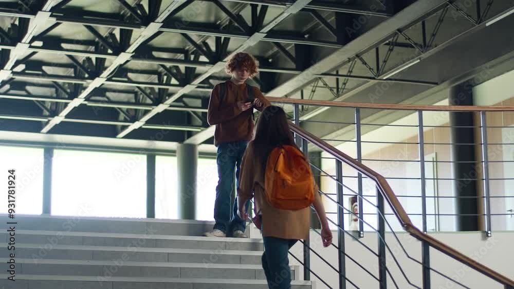Caucasian two friends students meeting in school stairs standing ...