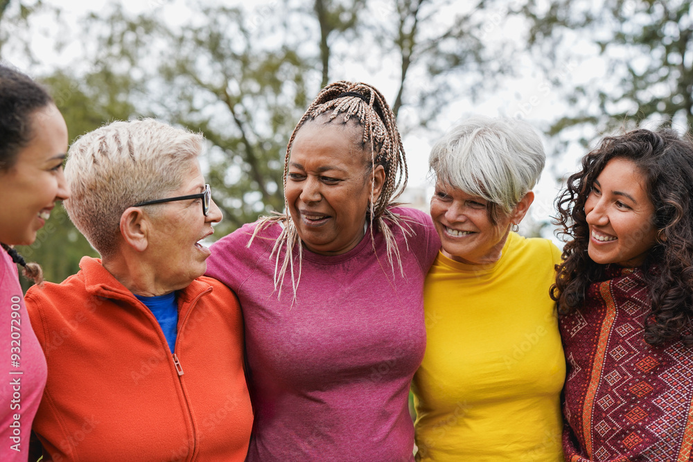 Group of multi generational women hugging each other at city park ...