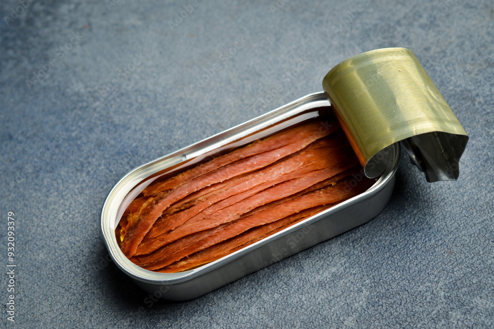 Salted anchovies in oil in a tin can. Canned food in aluminum cans. On ...
