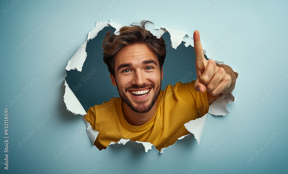 Junger Mann steckt den Kopf durch ein Loch in der Wand und zeigt ...