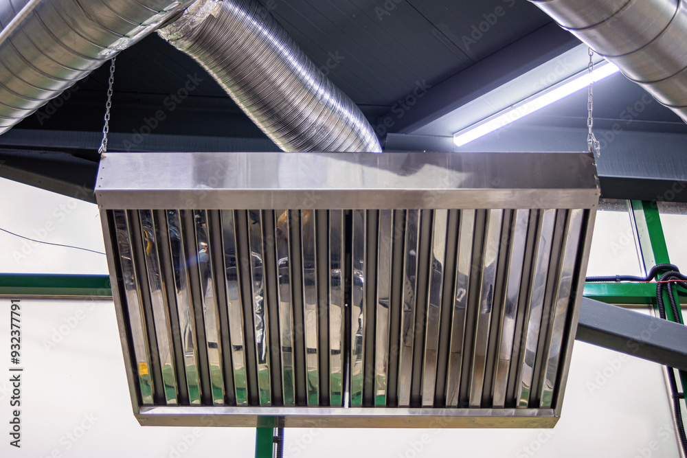 Stainless steel exhaust hood with grease trap close-up in a large ...