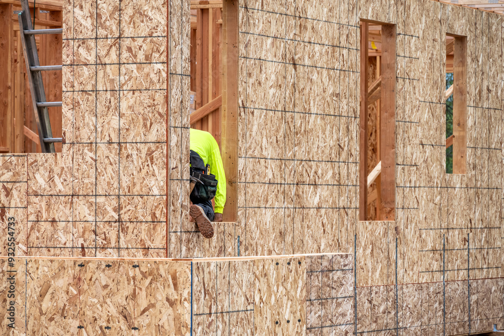 New residential home construction in framing stage, OSB, oriented strand board, sheathing on ...