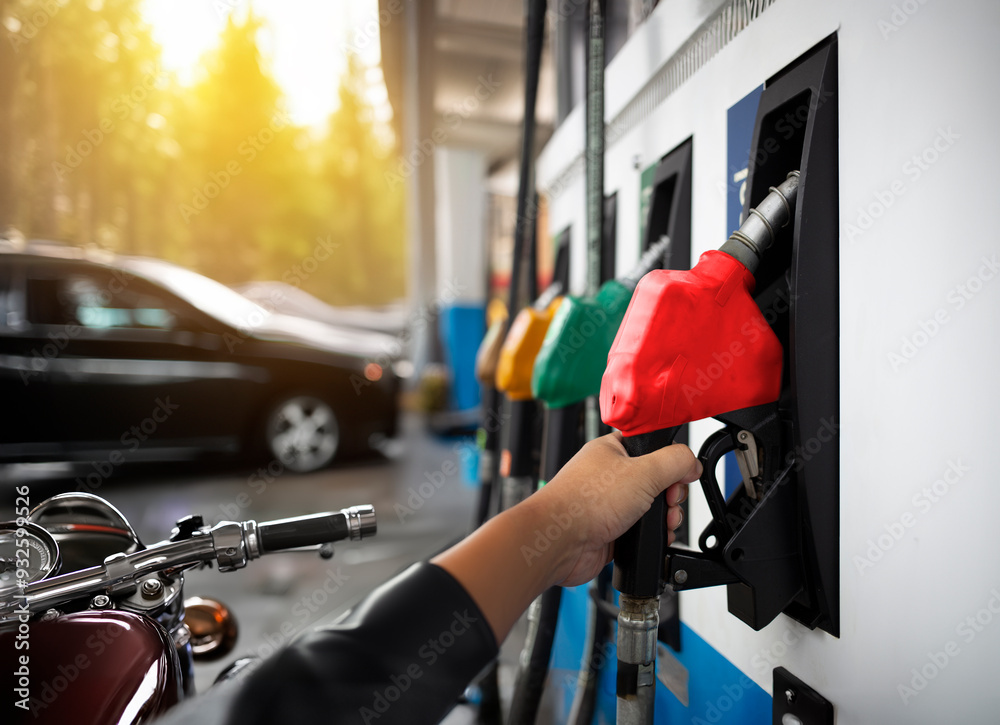 Motorcycle Biker hand pulling being filled up at a fuel pump for ...