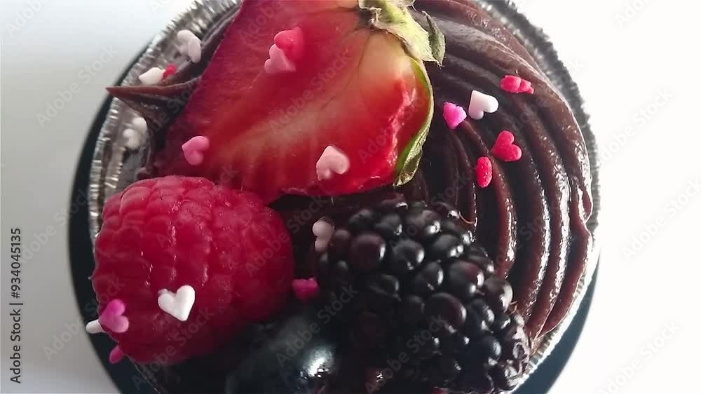 Top down view of chocolate mud cake with heartshaped sprinkles ...