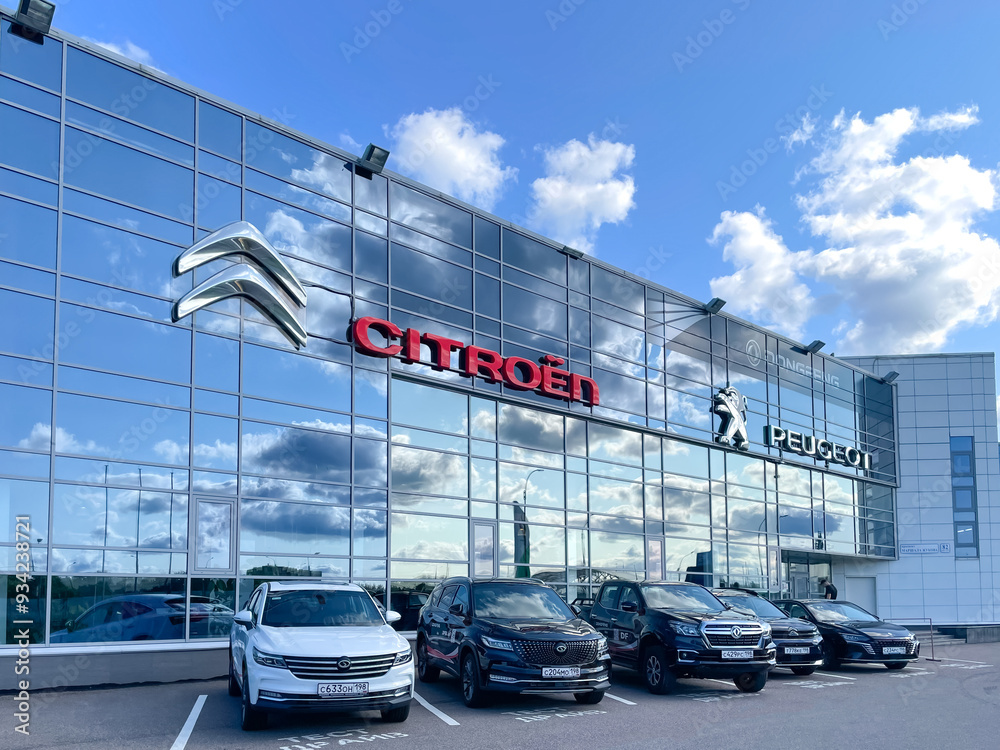 Citroen sign on glass facade of dealership building. Citroen logo and ...