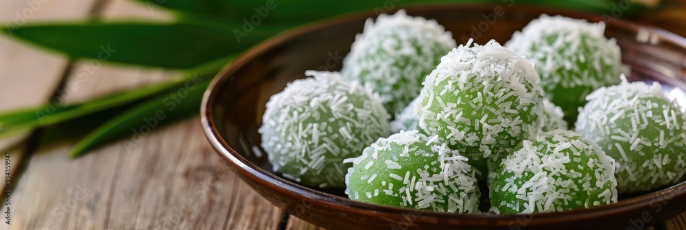 Klepon is a traditional dessert featuring green glutinous rice balls ...