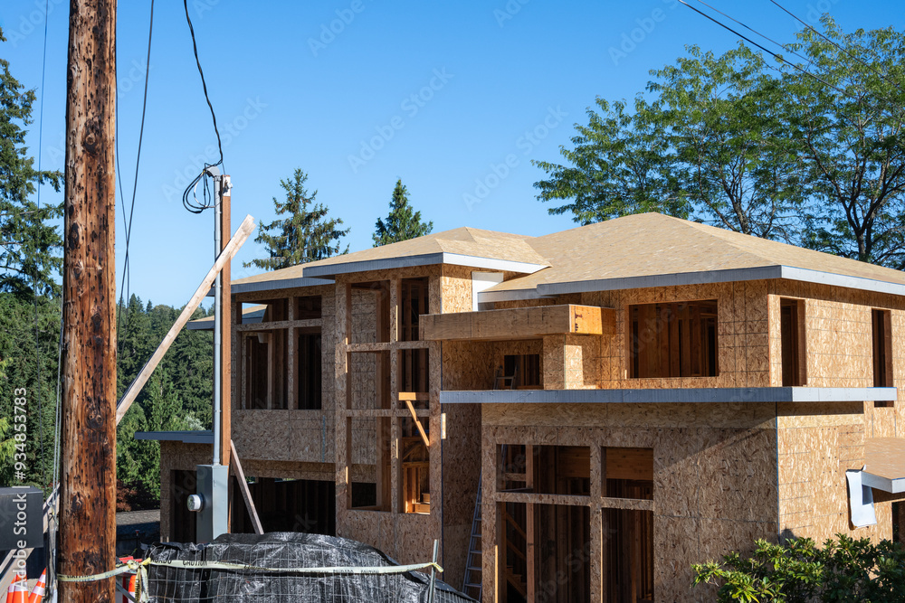 New large residential home construction in framing stage, with exterior ...
