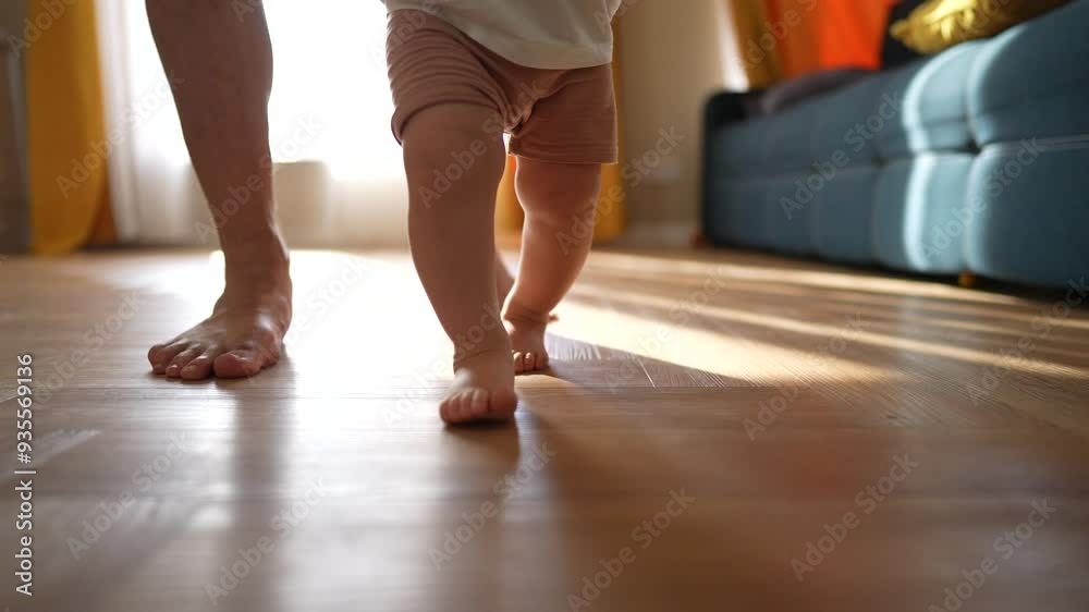 Daddy and baby taking the first steps. Child-father concept. A baby is ...