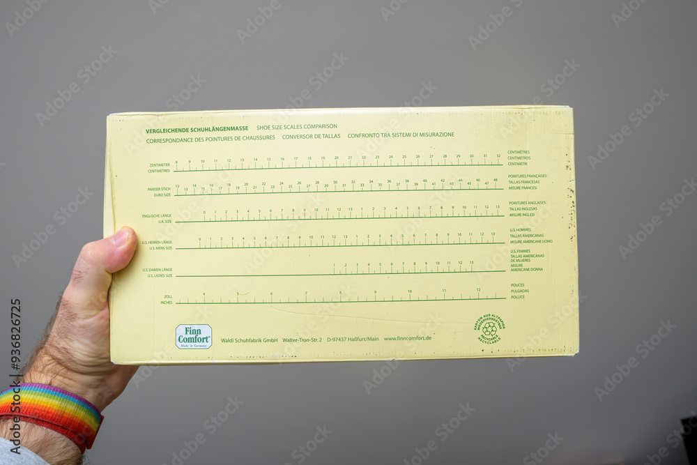 PAris, France - Dec 24, 2023: A male hand holding a Finn Comfort shoe ...