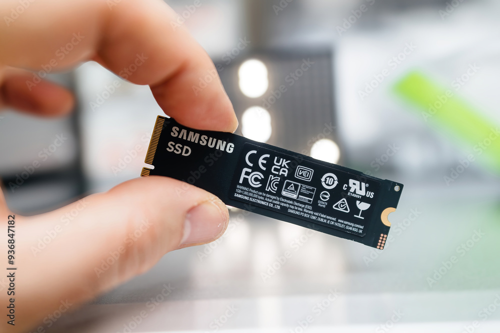 Paris, France - Apr 3, 2024: A male hand holds a Samsung SSD NVMe ultra ...