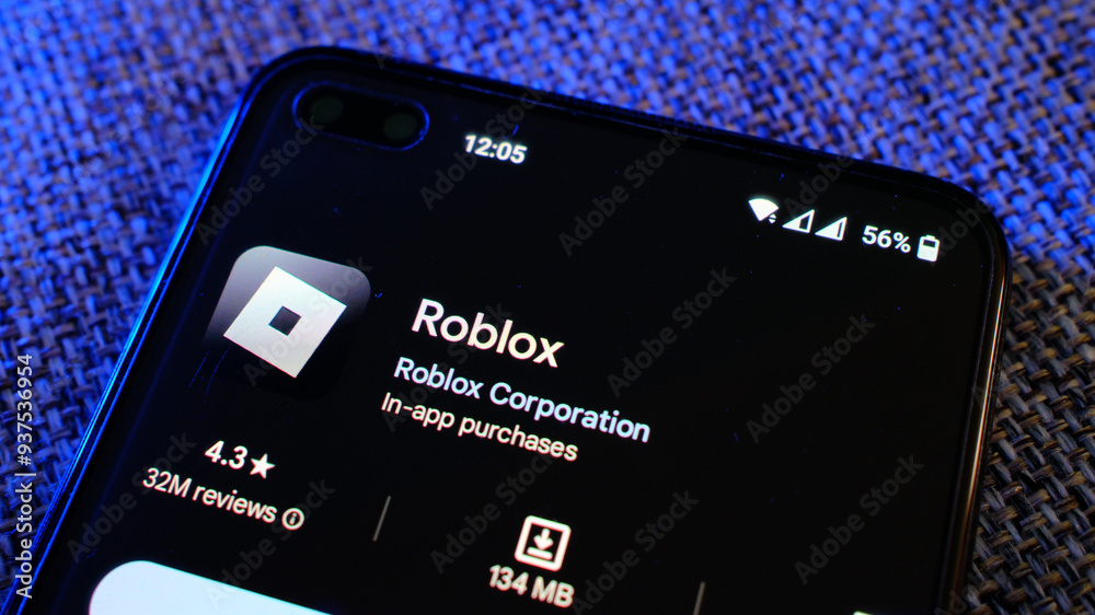 Roblox app in play store page on mobile phone display. London, UK, 08. ...