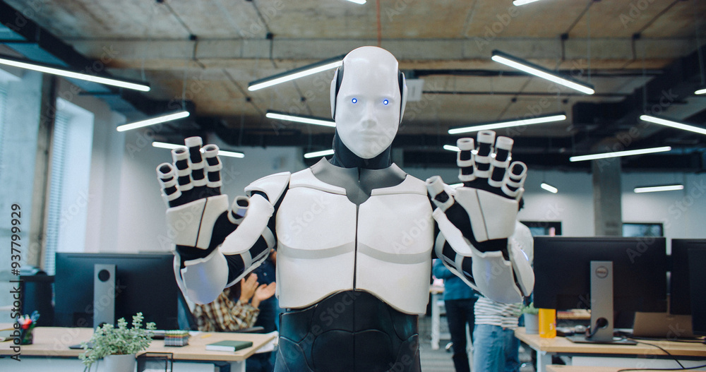 Modern robot walking down long isle in middle of office building ...