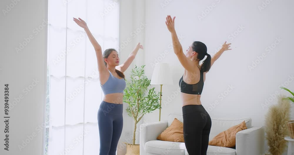 Two women in activewear performing Practicing yoga poses Together in a ...