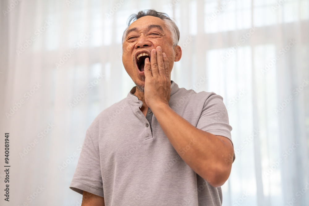 Senior asian man experiencing tooth pain, holding his cheek with pained ...