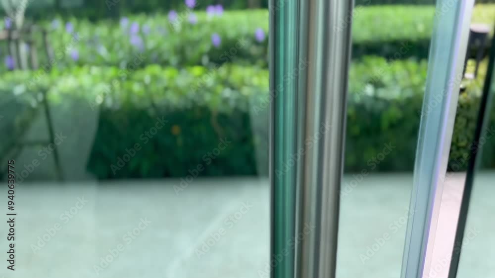 opening a glass door in an office, Modern pivot door with a glass panel ...