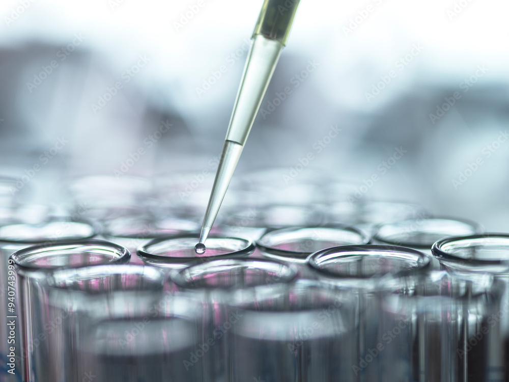 Extraction of samples from test tube using pipette in laboratory Stock ...