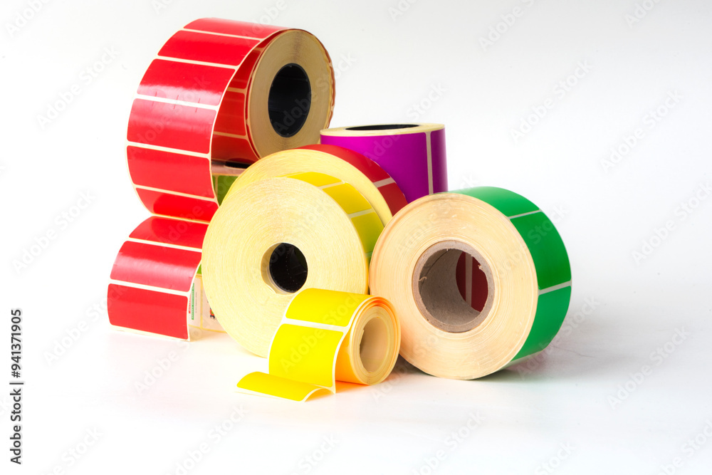 Reels of self-adhesive clean colored labels on a white background on ...