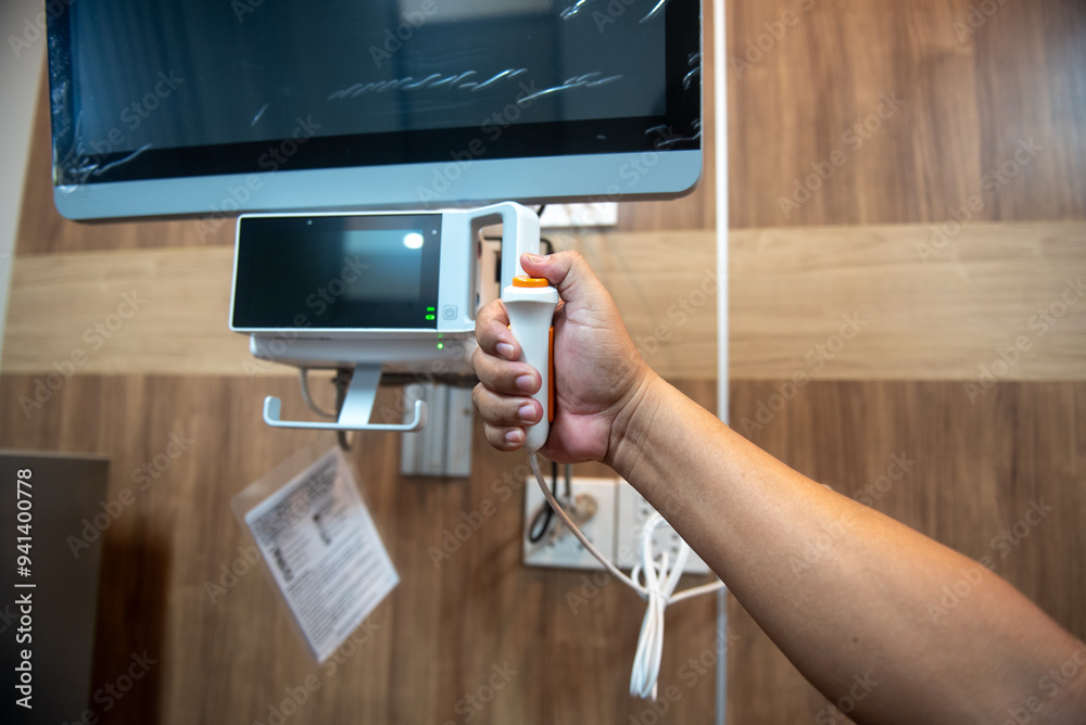 Hand presses nurse call button. The patient presses emergency button to ...