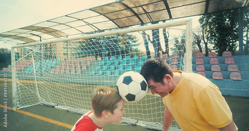 Father and Son play football on stadium, Happy family outdoors, bonding ...