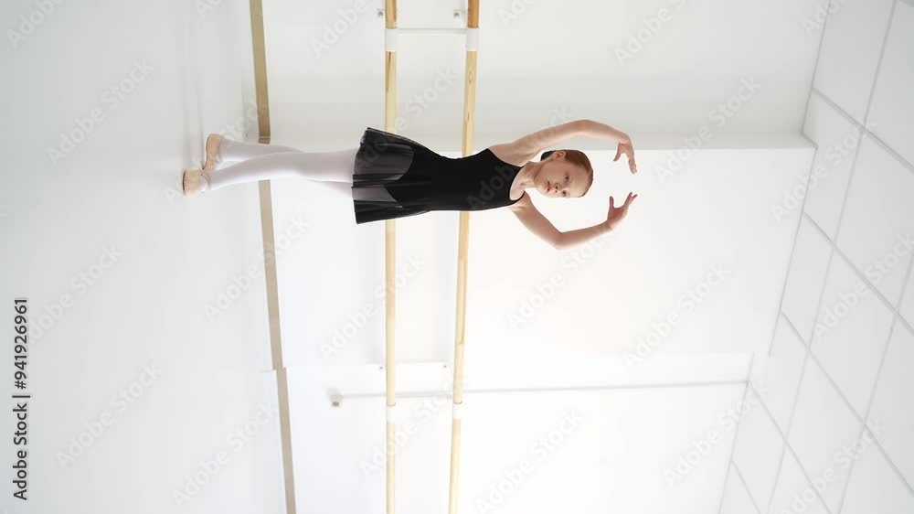 Young ballet girl at studio lesson. Training performance. Stretching ...